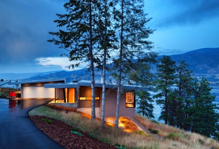 Lake View Home with modern silhouette nestles in beautiful landscape ...