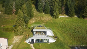 Casa Jura by JDS Architects is a two-story house built into hillside