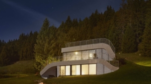 Casa Jura by JDS Architects is a two-story house built into hillside