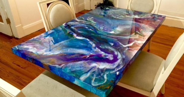 Dining tabletop resembles to cloud of gas and dust in outer space