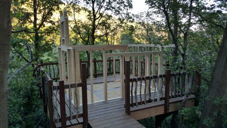 This DIY built mini treehouse in Western US features a slide for kids