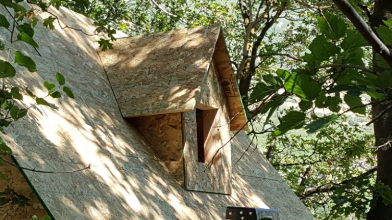 This DIY built mini treehouse in Western US features a slide for kids