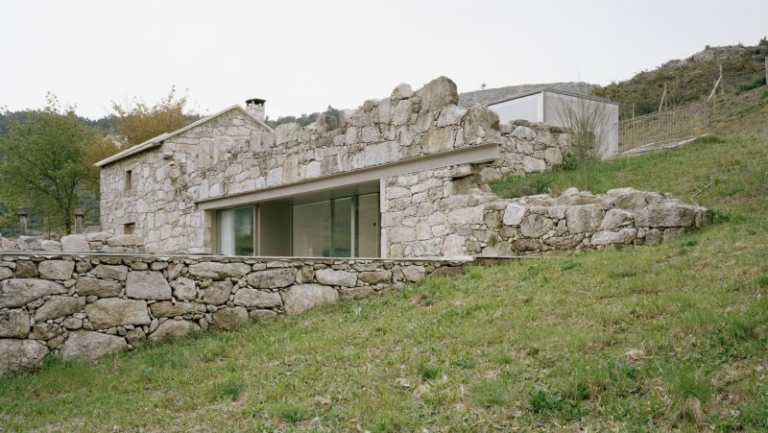 Old stone house in ruins transformed into modern vacation home