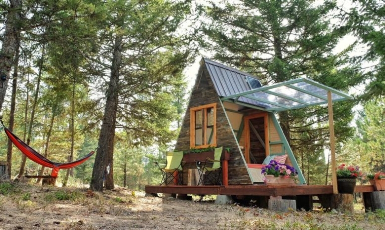 This solar-powered A-frame cabin features a retractable wall
