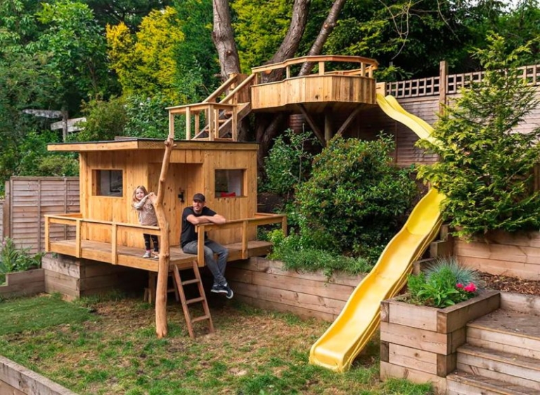 Dad Builds Garden Treehouse with Slides For His Daughters