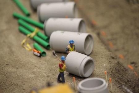 Live-Edge Boardroom Table Hides an Entire Construction Site Within