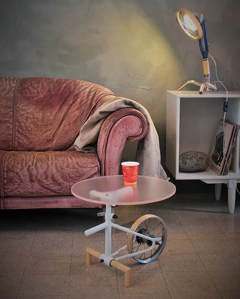 Designer Transforms Discarded Bicycle Into Coffee Table with White Motif