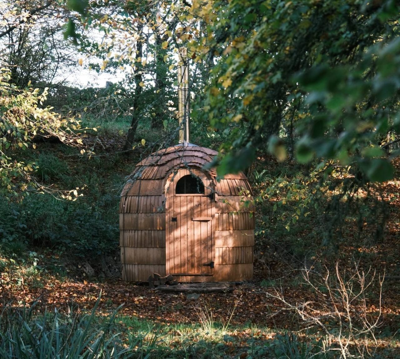 Iglusauna Prefab Sauna Blends in Nature With Stunning Shingles