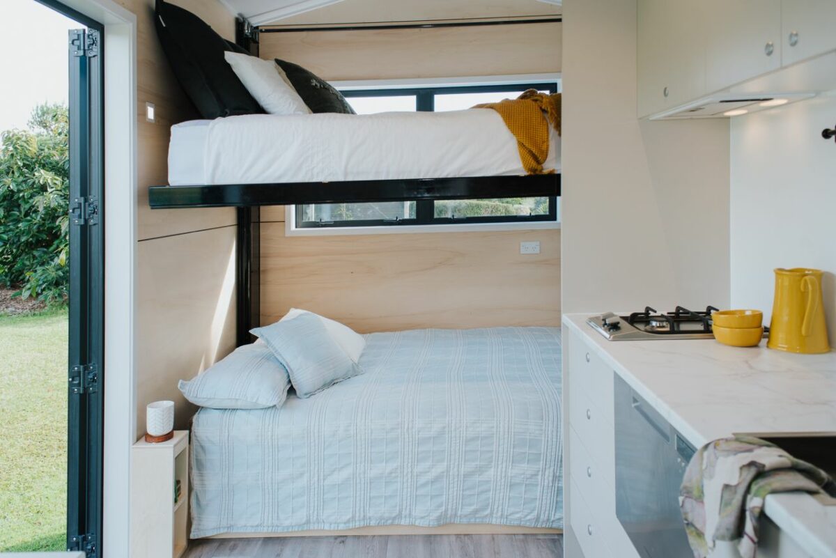 Camper Tiny House Features Drop-Down Ceiling Bed, Sofa Bed
