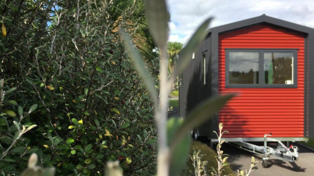 Camper Tiny House Features Drop-Down Ceiling Bed, Sofa Bed