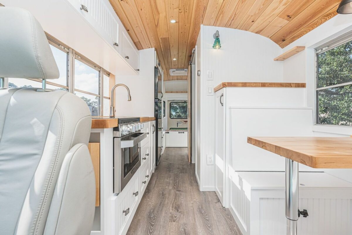 Movable Roots' Skoolie Offers Multifunctional Spaces and Patio