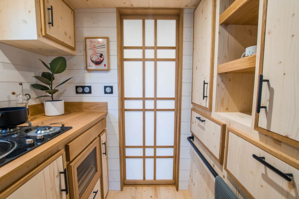 Bonzai Tiny Home Features a Futon, Projector, & Pull-Down Screen