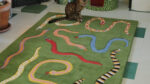 Snakes in the Grass Rug is Vibrant Tapestry of Slithering Reptiles