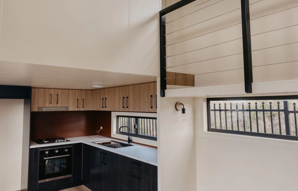 Dawson Tiny House Employs Gantry Walkway to Connect Two Lofts