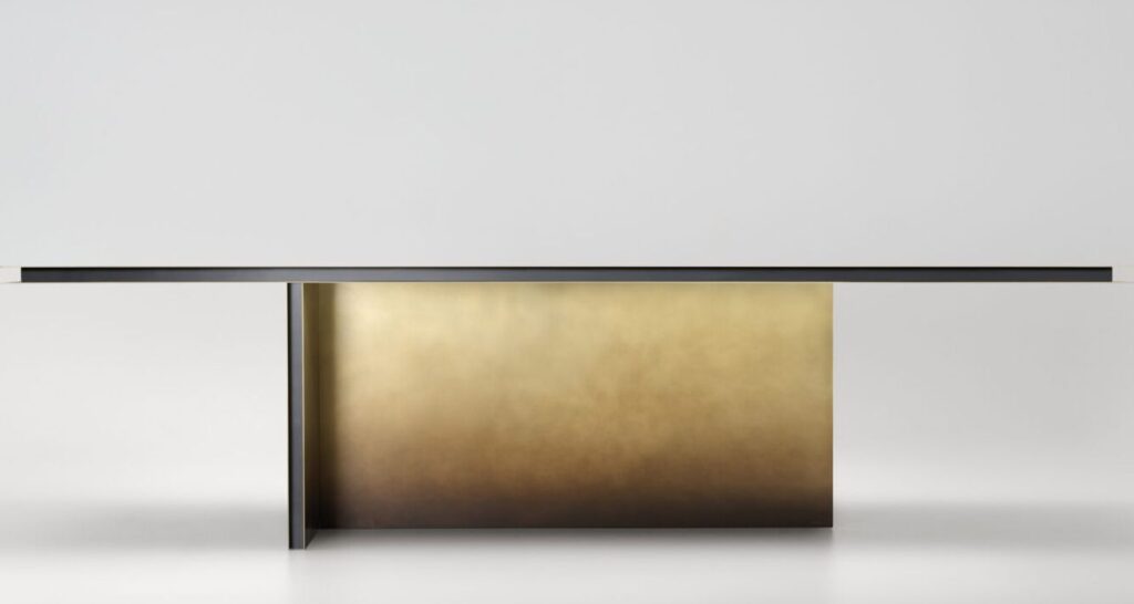 Folio Table With Perpendicular Brass Planes Adds Spice to Bland Space