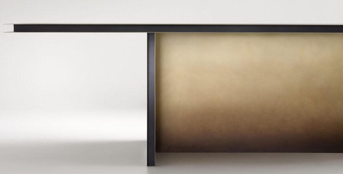 Folio Table With Perpendicular Brass Planes Adds Spice to Bland Space