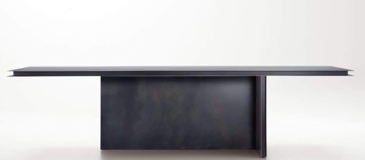 Folio Table With Perpendicular Brass Planes Adds Spice to Bland Space