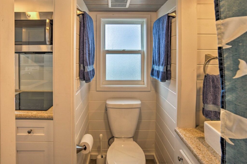 Waterfront Tiny House With Bay Window Offers Twin Lofts