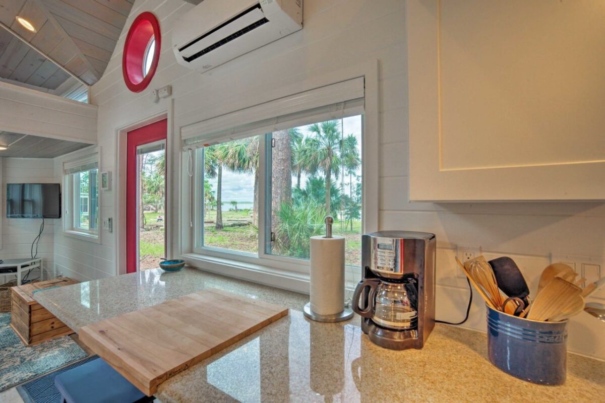 Waterfront Tiny House With Bay Window Offers Twin Lofts