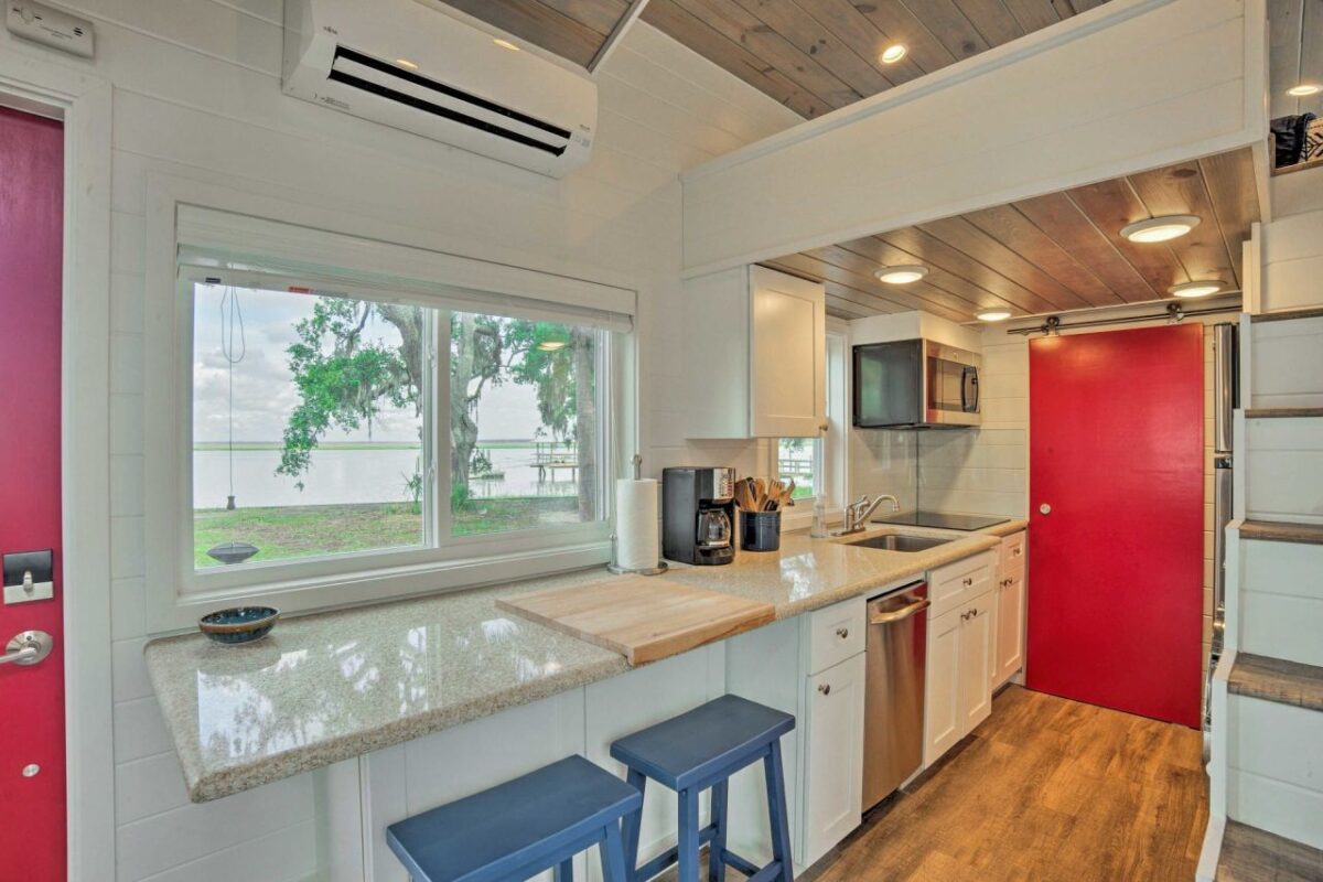 Waterfront Tiny House With Bay Window Offers Twin Lofts