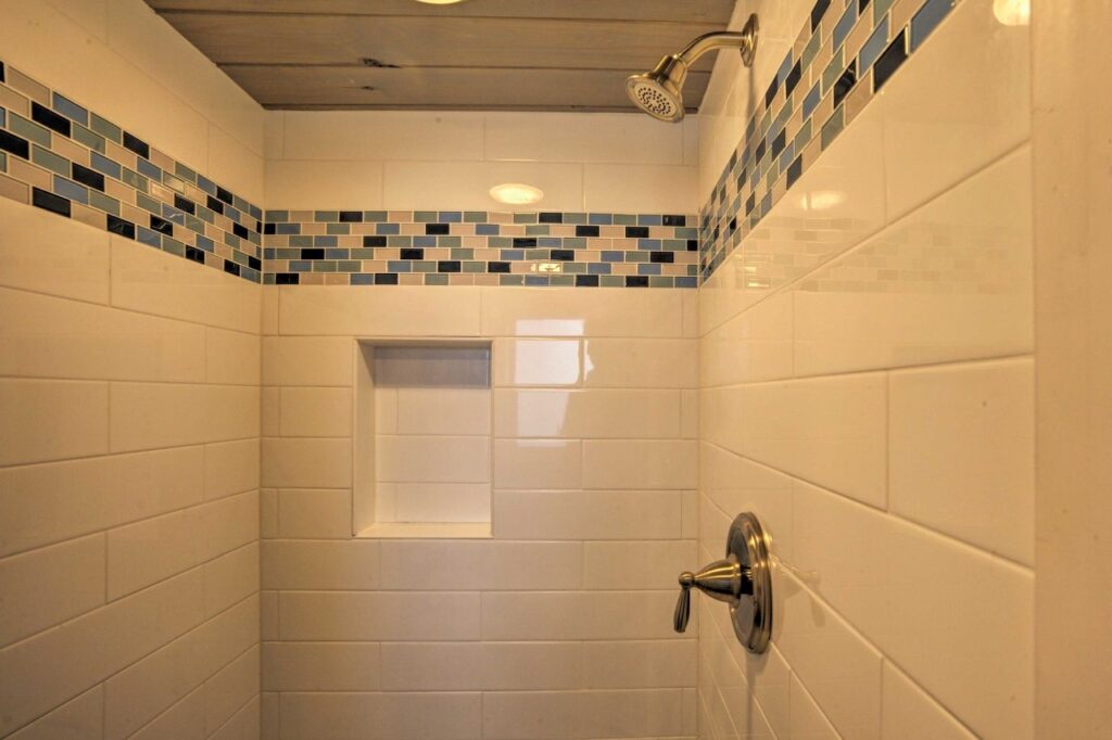 Waterfront Tiny House With Bay Window Offers Twin Lofts