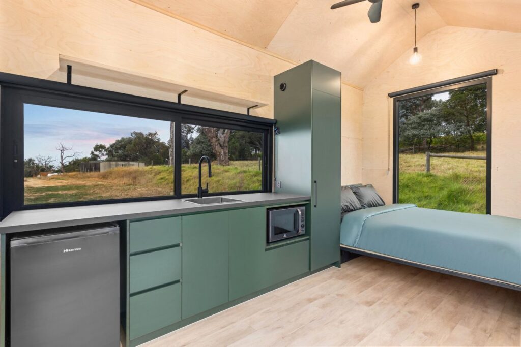 Freedom Tiny House Features Oversized Windows and a Skylight