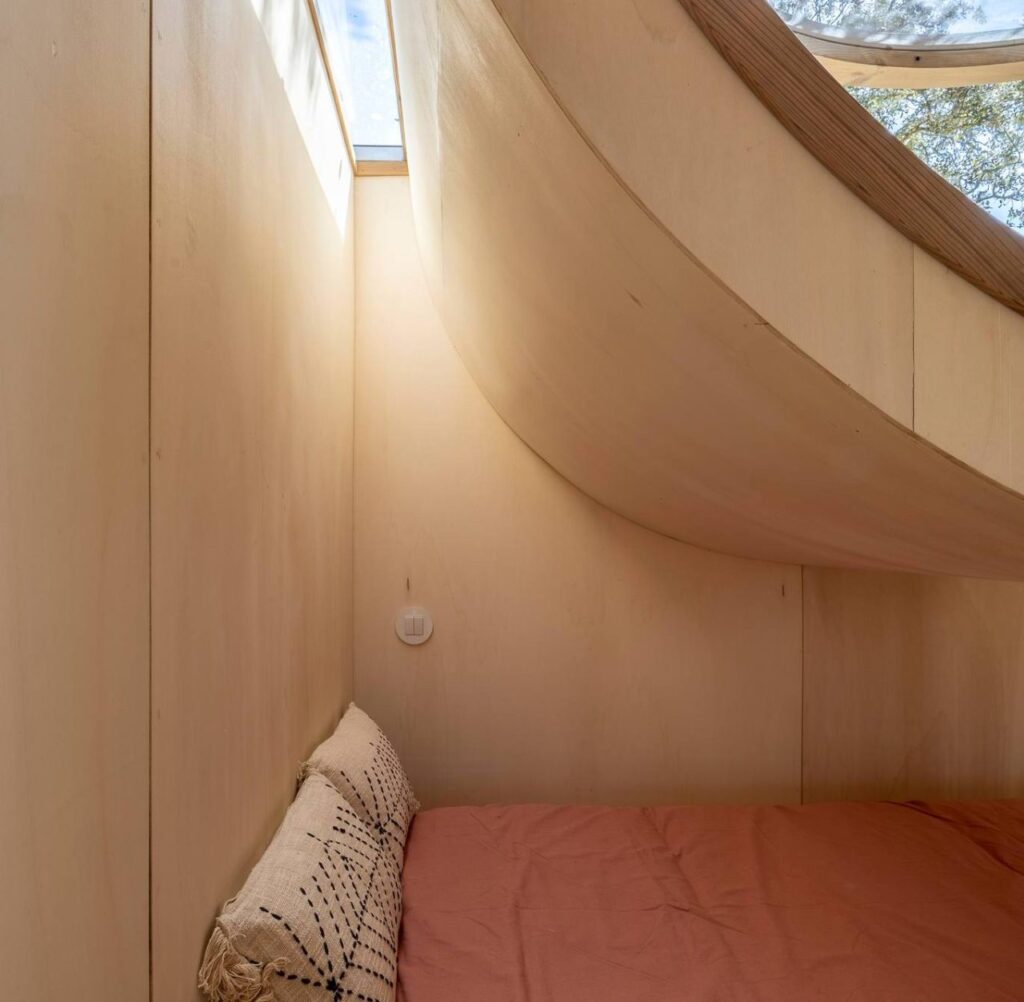 Tiny House has Round Pivot Window to Escape Onto Odd Balcony