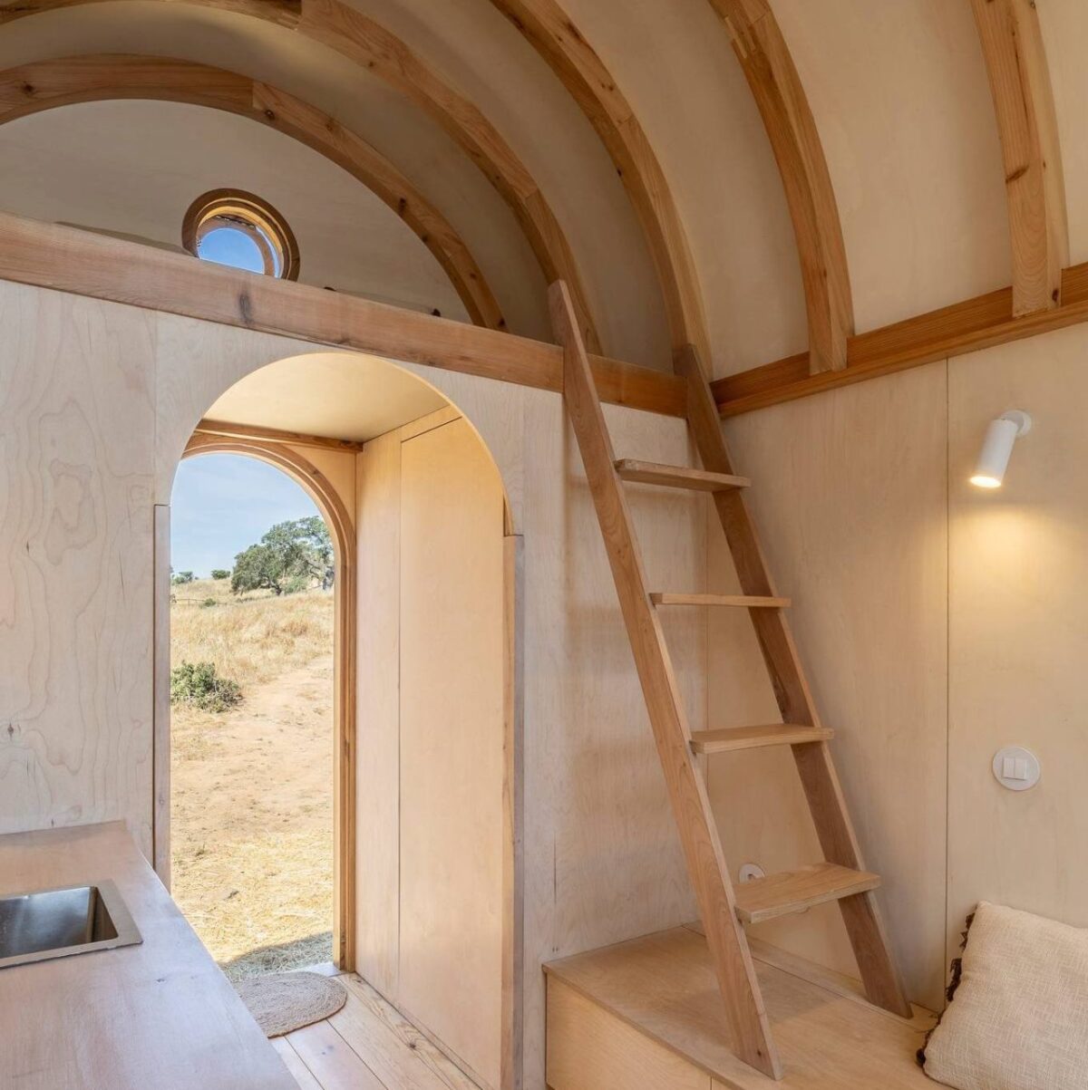 Tiny House has Round Pivot Window to Escape Onto Odd Balcony