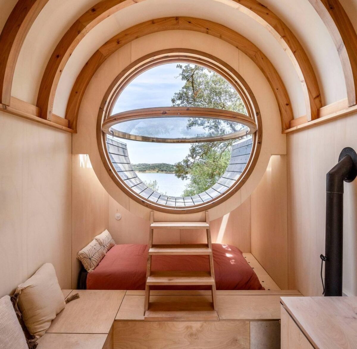 Tiny House has Round Pivot Window to Escape Onto Odd Balcony
