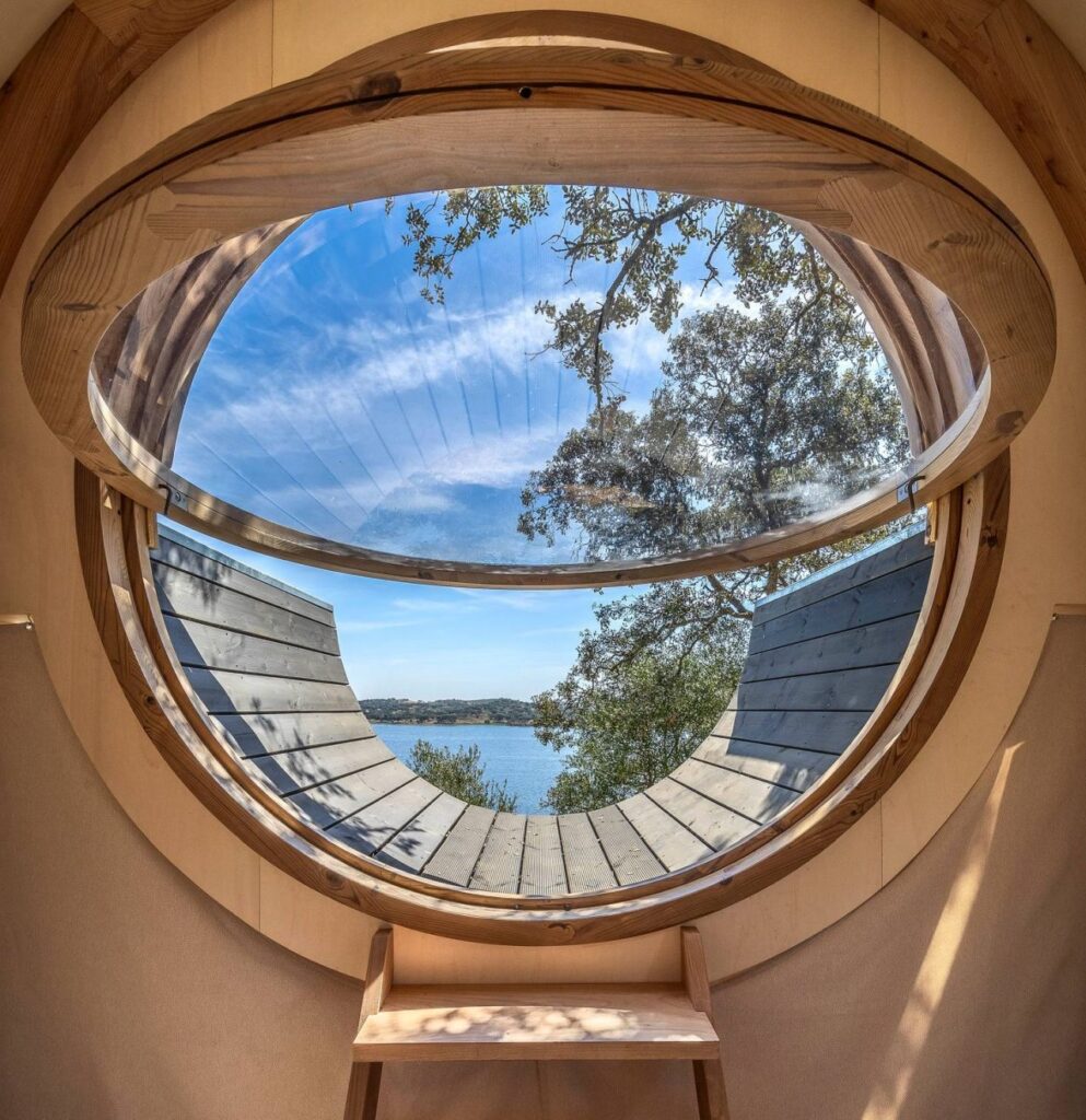Tiny House has Round Pivot Window to Escape Onto Odd Balcony