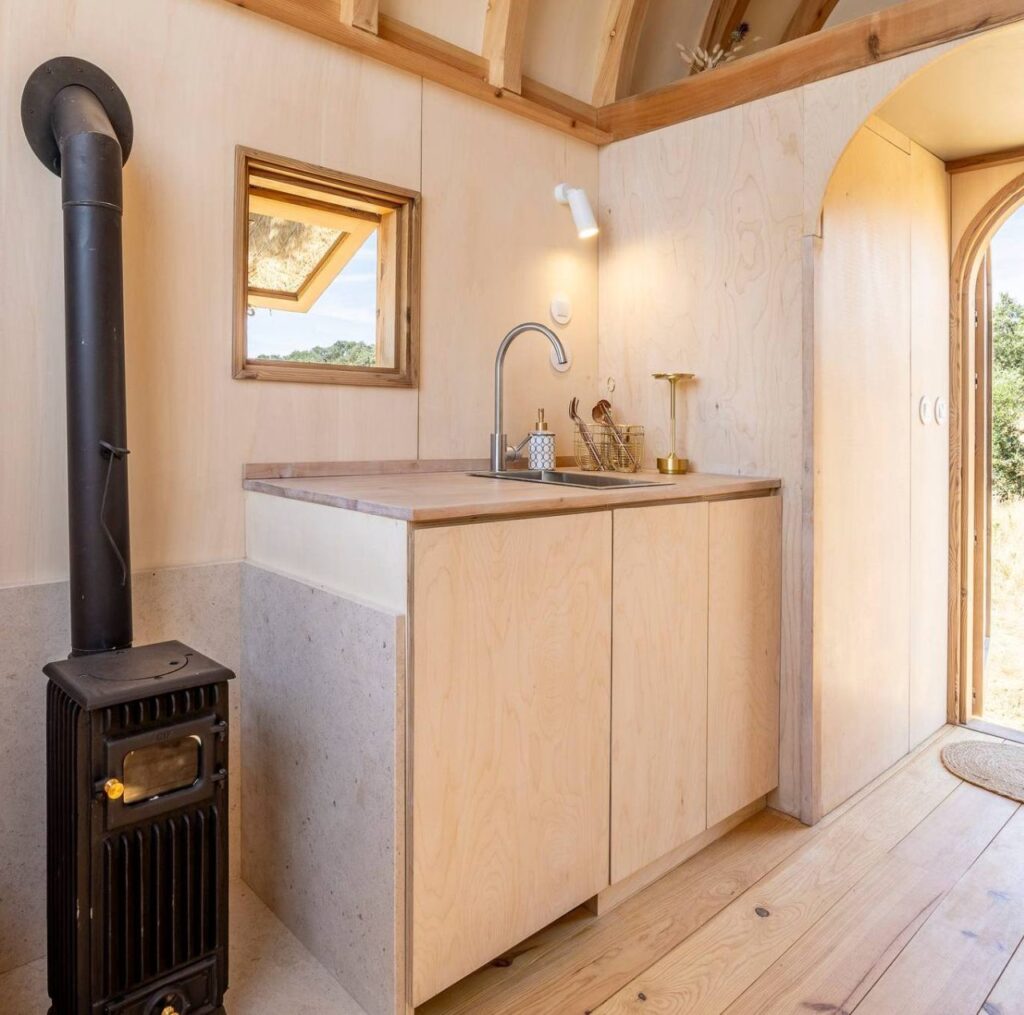 Tiny House has Round Pivot Window to Escape Onto Odd Balcony